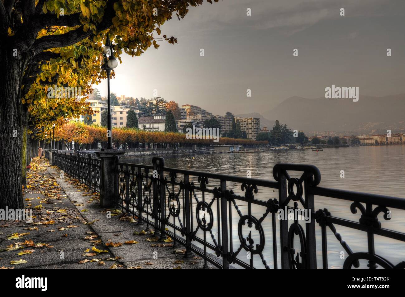 Lake front in city of Lugano, with autumn trees,Ticino, Switzerland ...