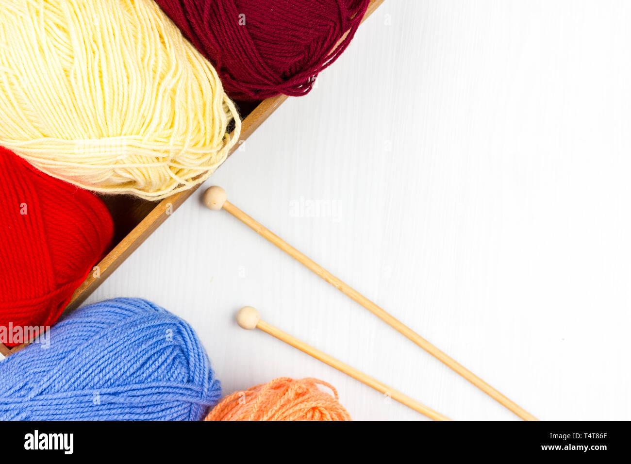Flatlay of multicolored pastel knitting skeins of yarn and knitting ...