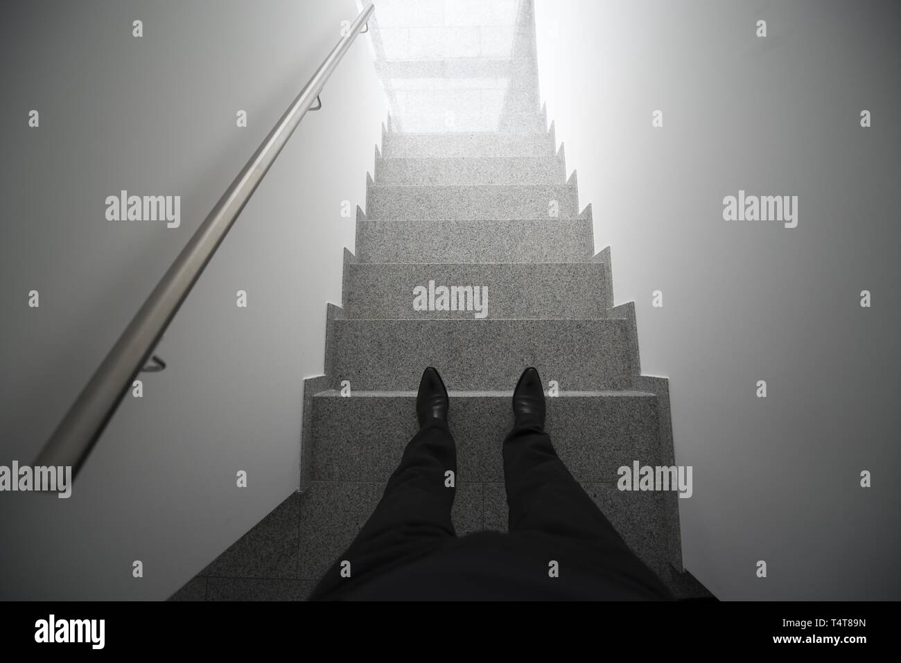 Man standing in the staircase with window light Stock Photo - Alamy