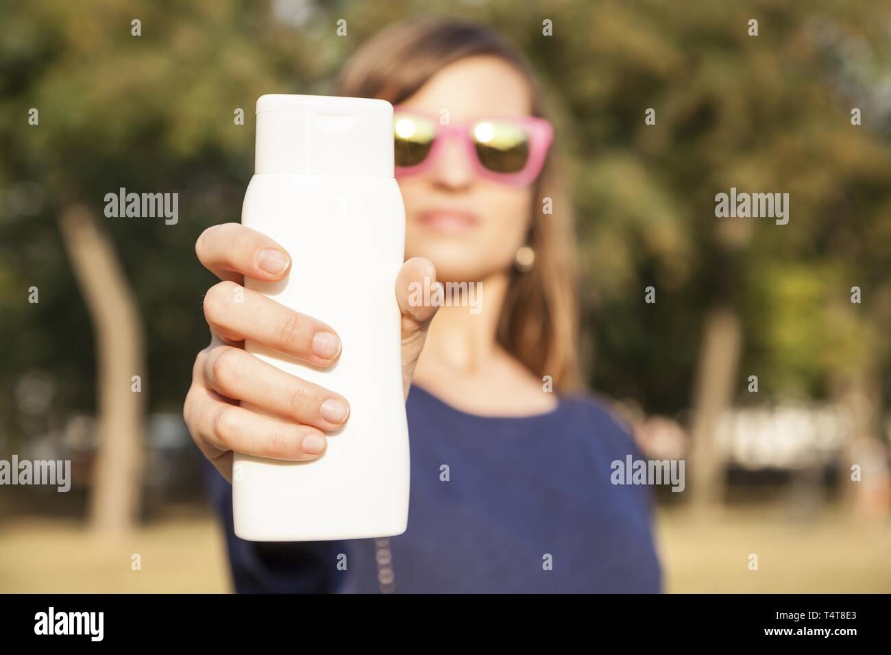 Young woman showing a sunscreen, Germany Stock Photo - Alamy