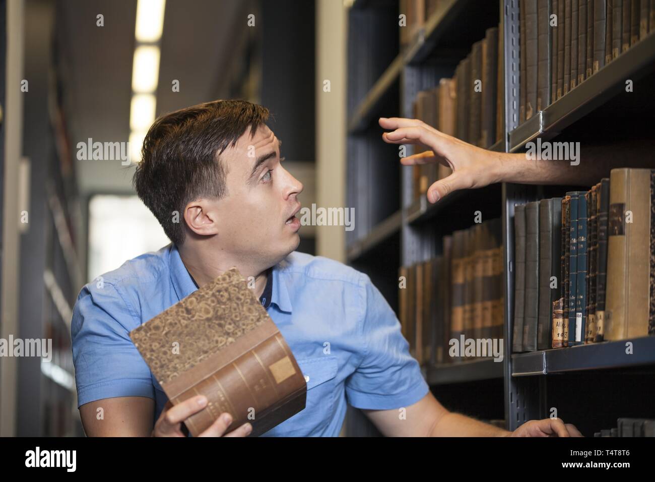 Student will be frightened in a library Stock Photo - Alamy