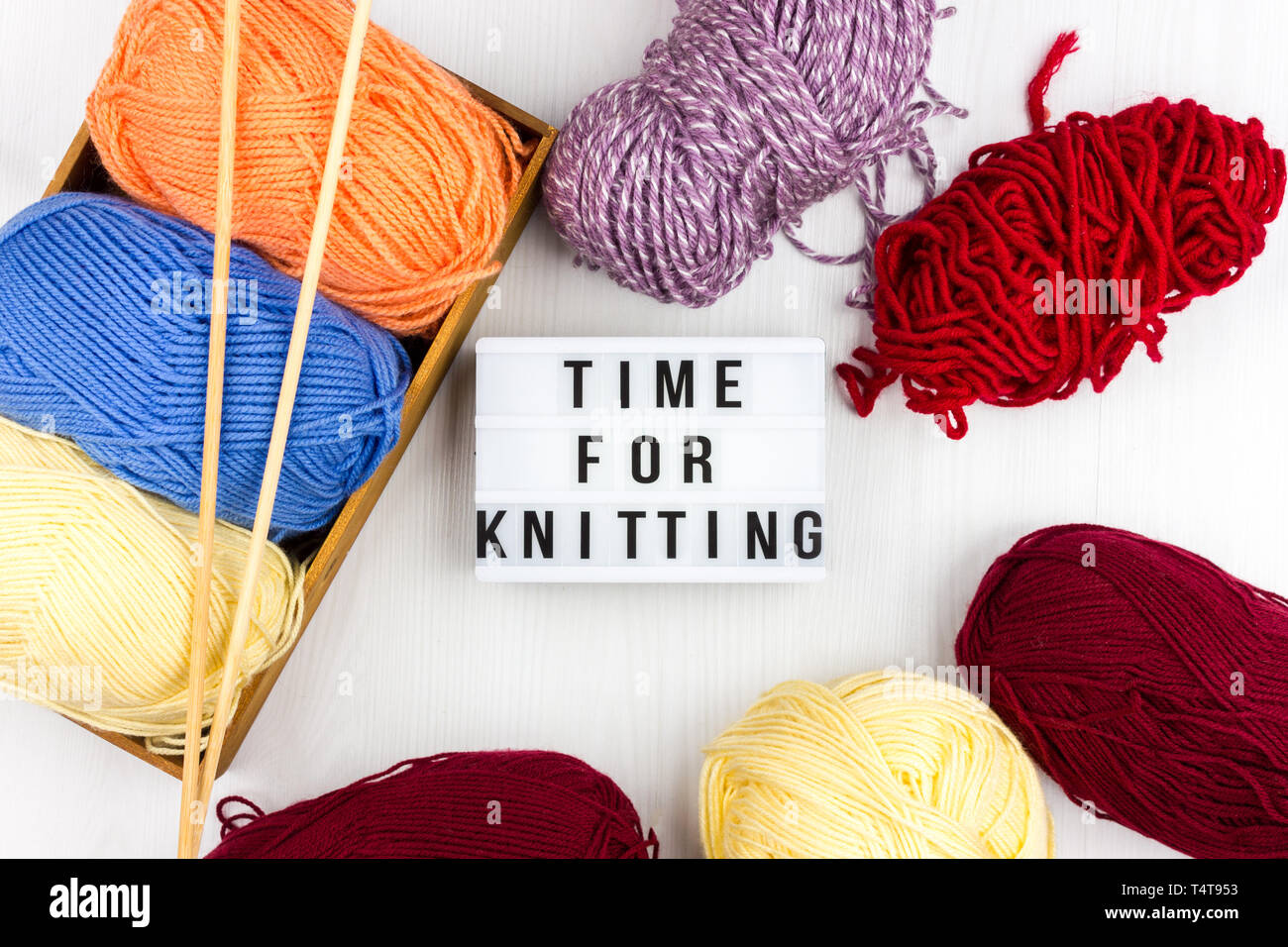 Flatlay of multicolored pastel knitting skeins of yarn and knitting ...