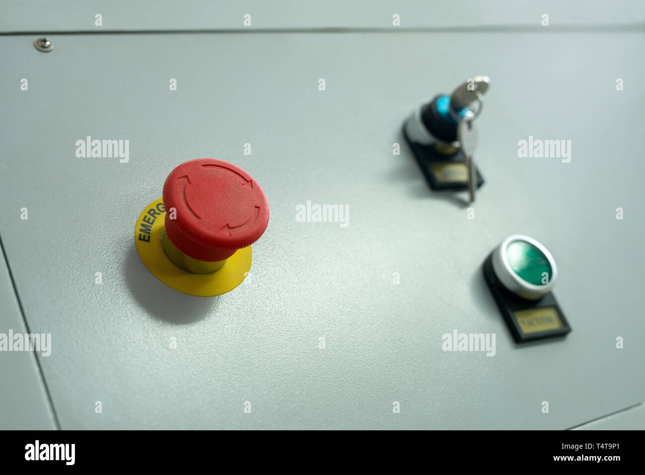 Red emergency button on control panel of modern industrial machine on ...