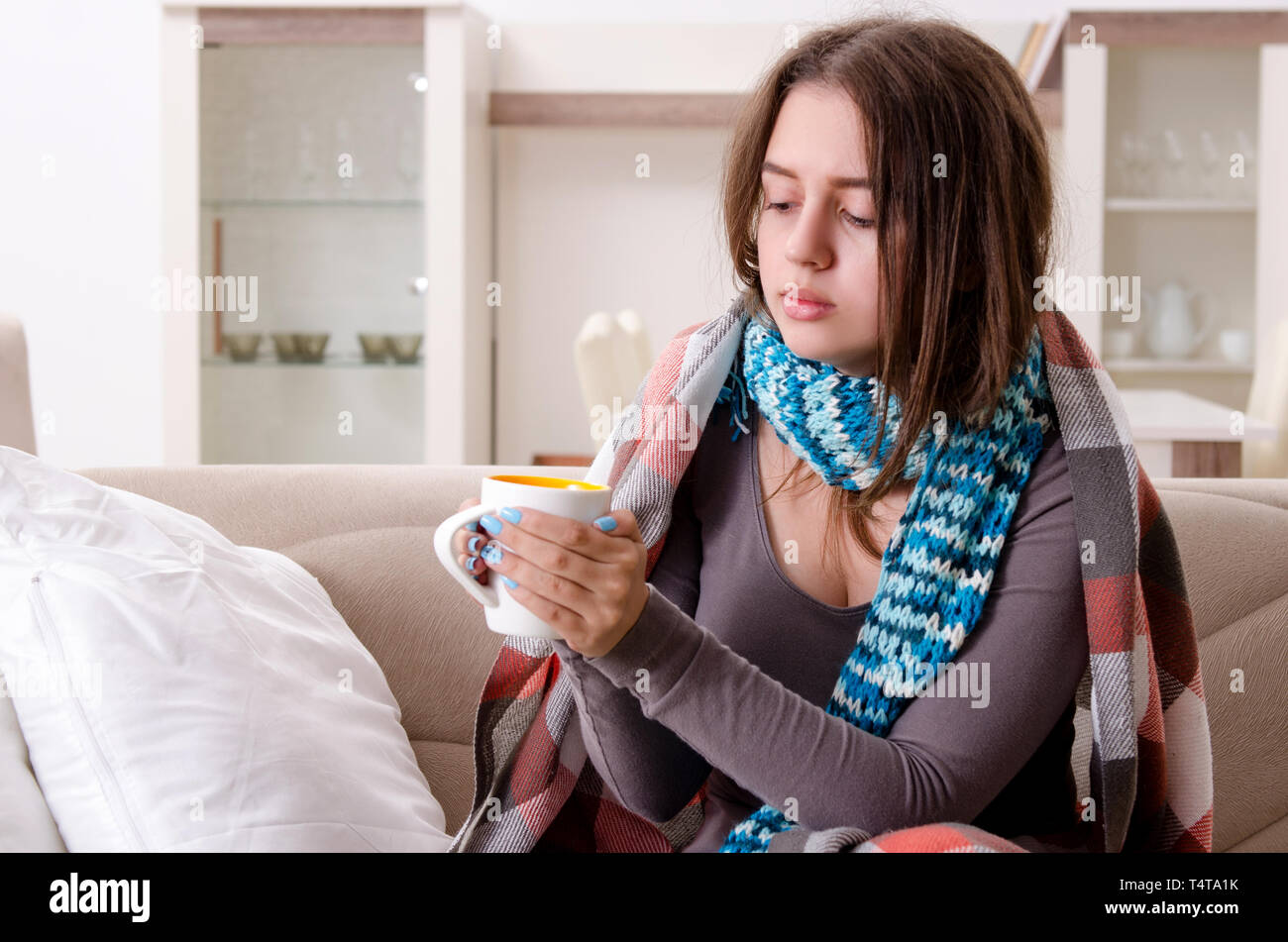 Sick young woman suffering at home Stock Photo - Alamy