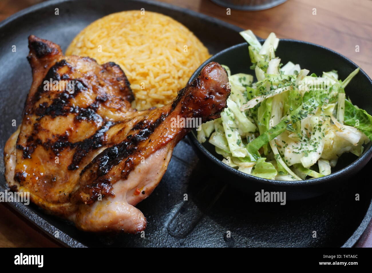 Delicious tasty chicken thigh bbq sauce with yellow rice and caesar ...