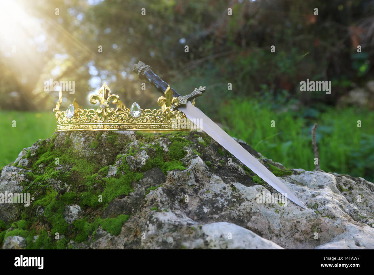 mysterious and magical photo of gold king crown and sword in the ...