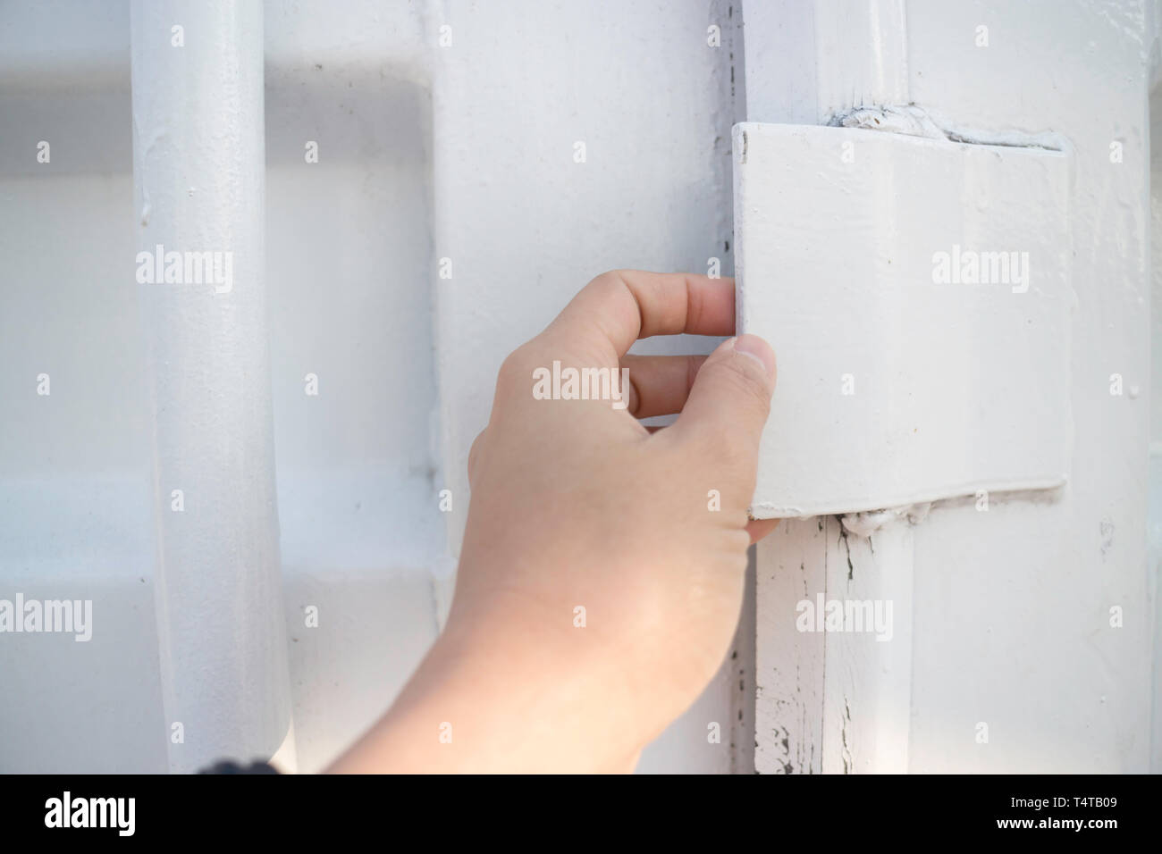 Hand on cargo container door, stock photo Stock Photo - Alamy