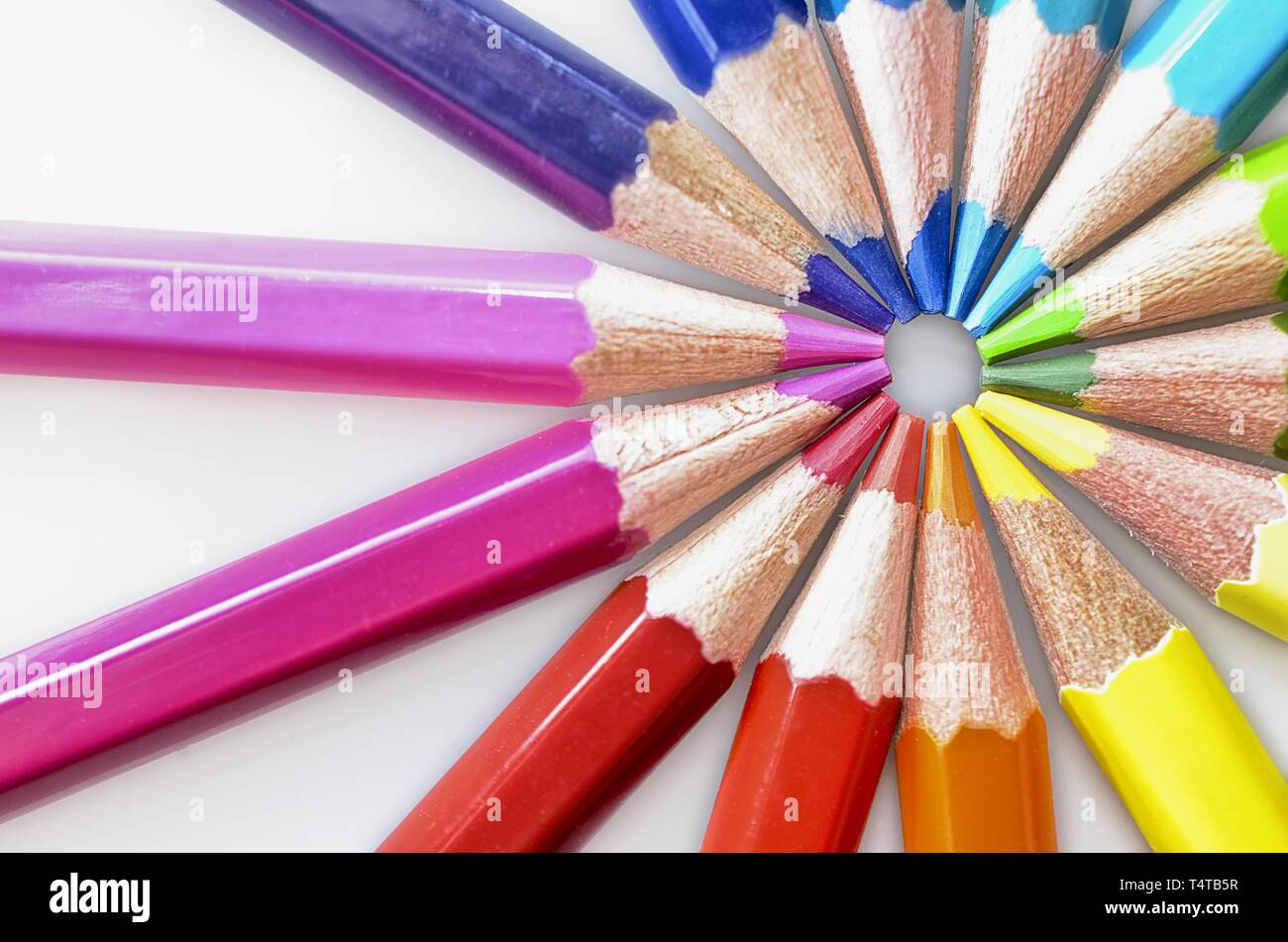Many crayons in a circle on white background Stock Photo - Alamy