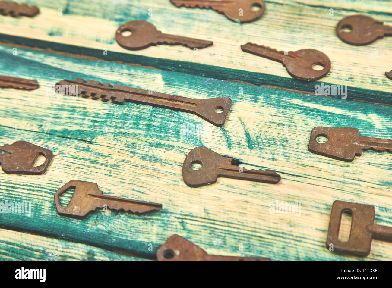 Collection of many different old retro keys in order on wooden rustic ...