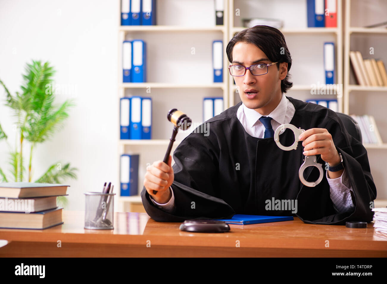 Young handsome judge working in court Stock Photo - Alamy