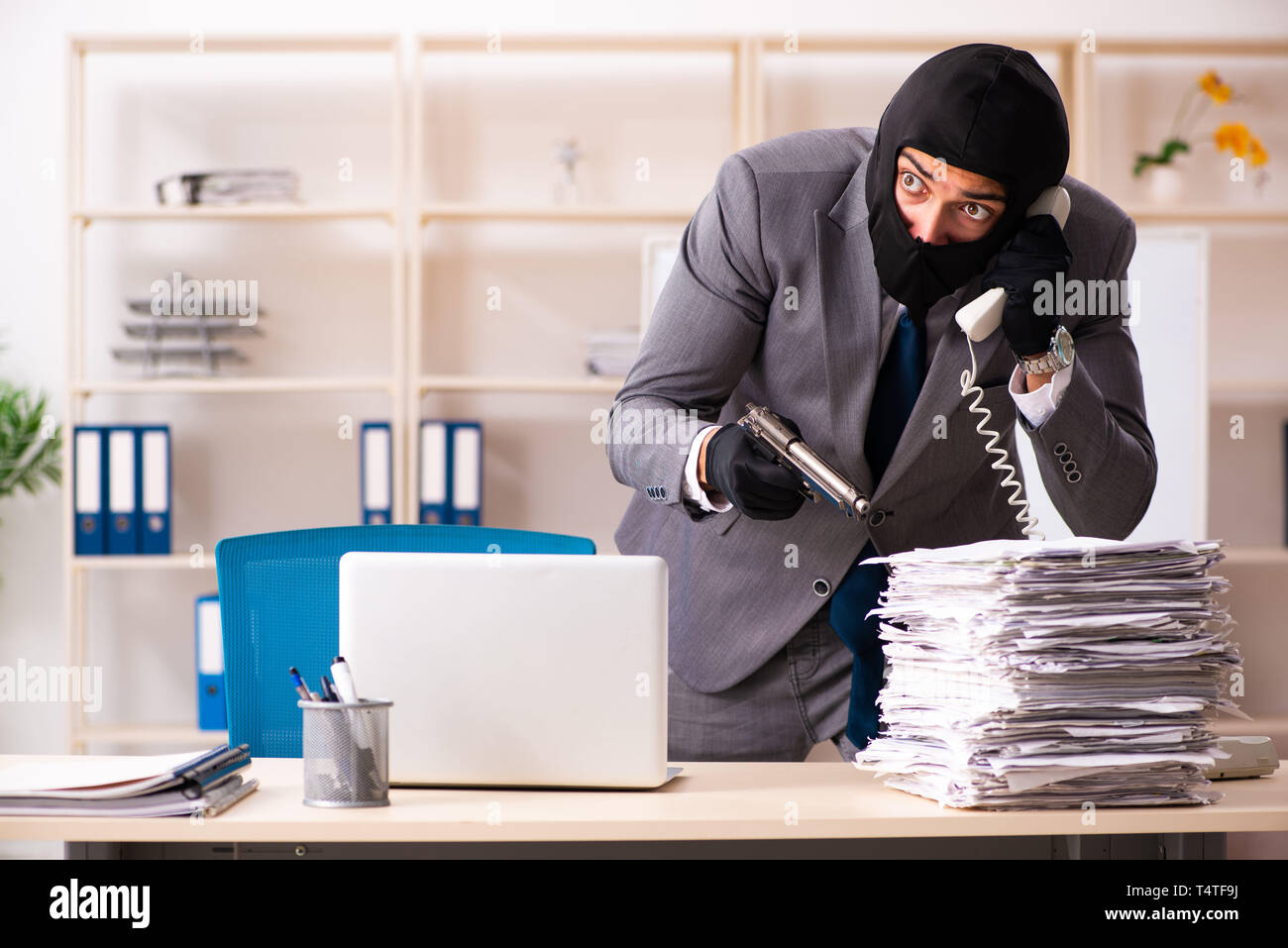 Male gangster stealing information from the office Stock Photo - Alamy