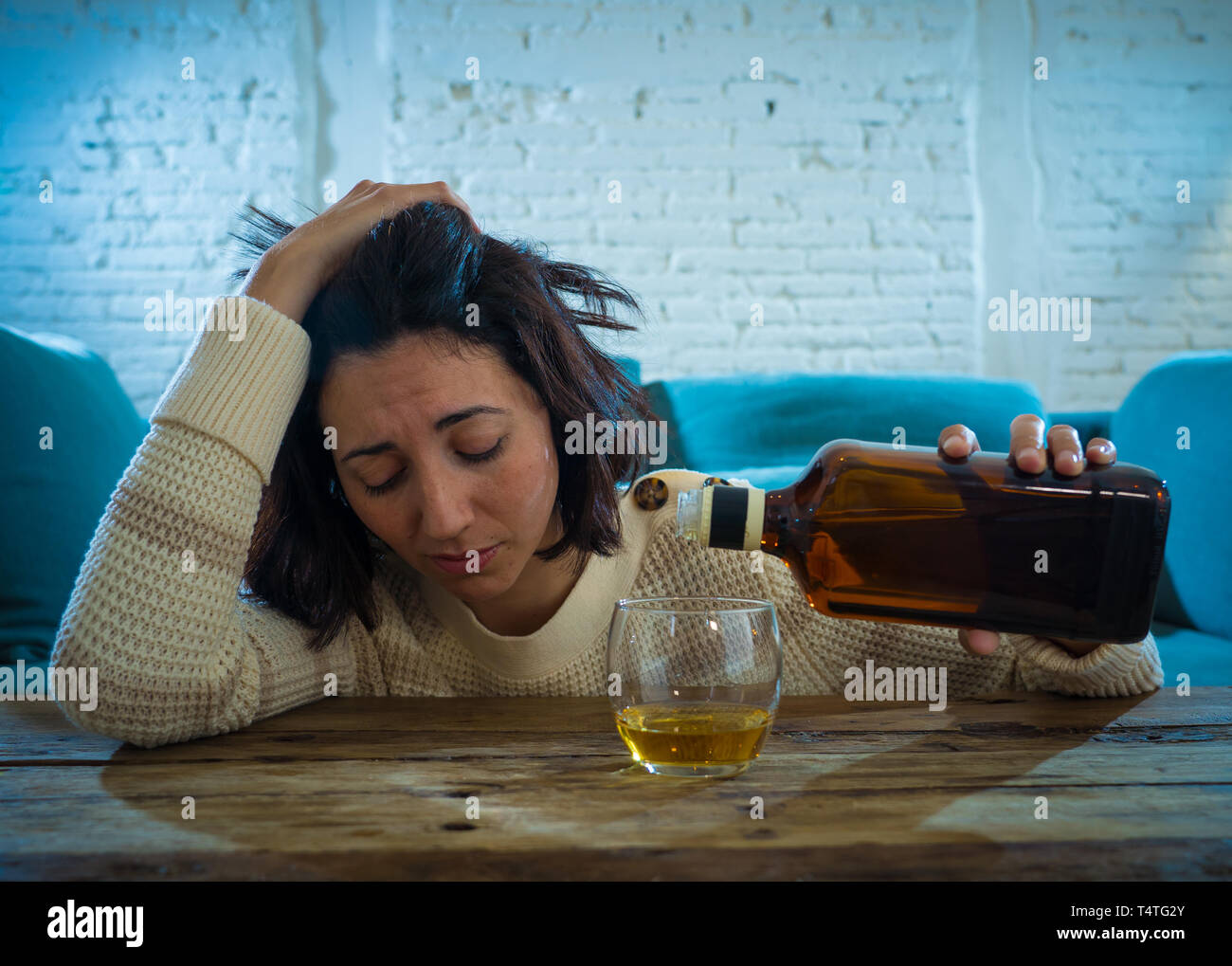 Drunk alcoholic depressed woman drinking scotch whiskey spirits alone ...
