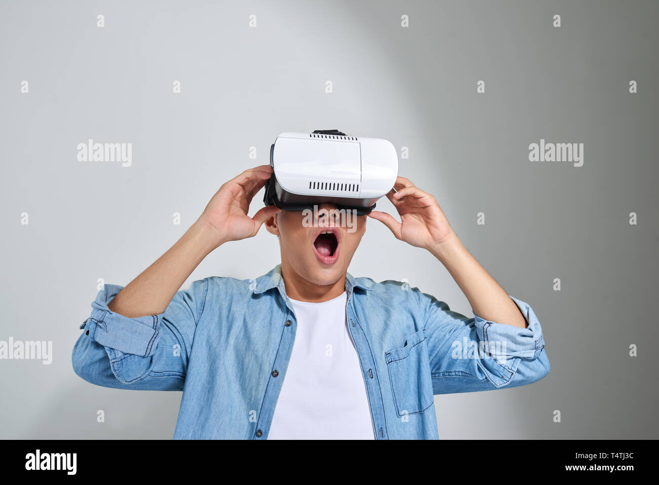Asian young man wearing virtual reality headset Stock Photo - Alamy