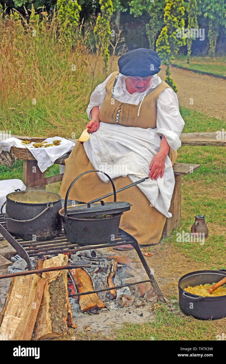 Tudor Woman Cooking Food on Open Fire, Reconstruction Stock Photo - Alamy