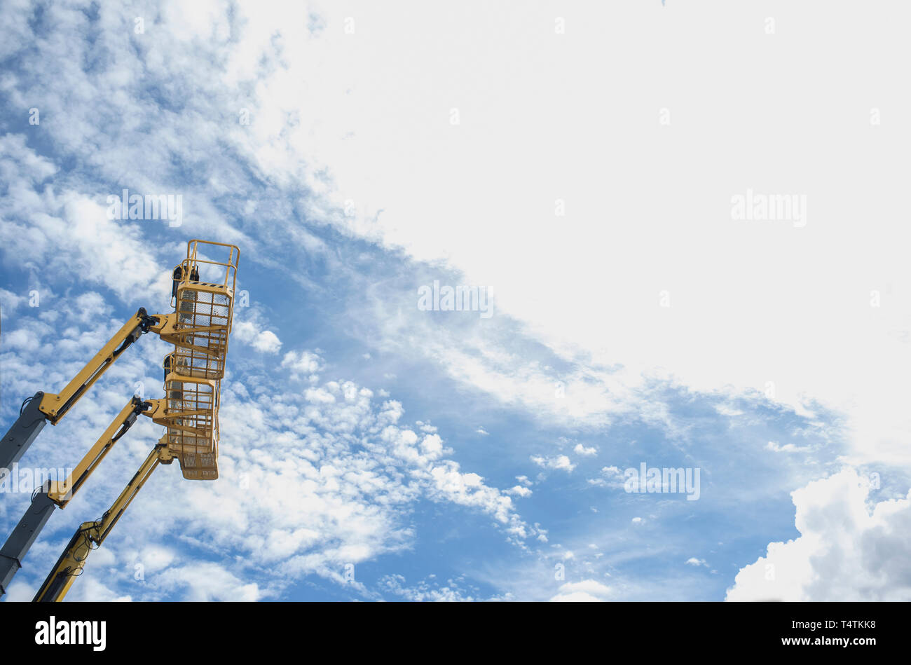 Telescopic Booms. Some platforms lifted over blue sky Stock Photo - Alamy