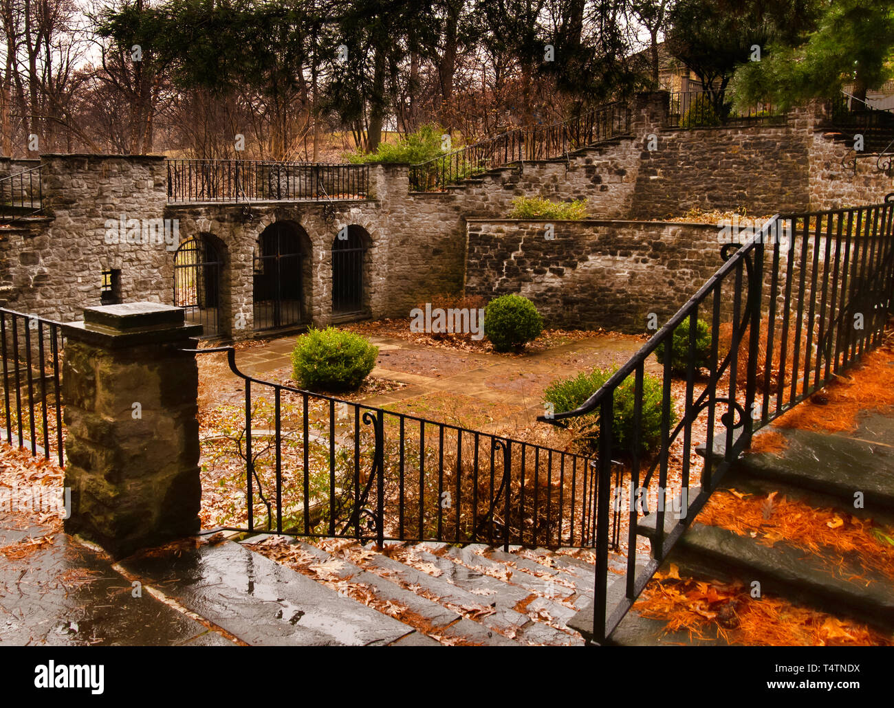 steps leading down to a ornamental sunken garden on a rainy early ...
