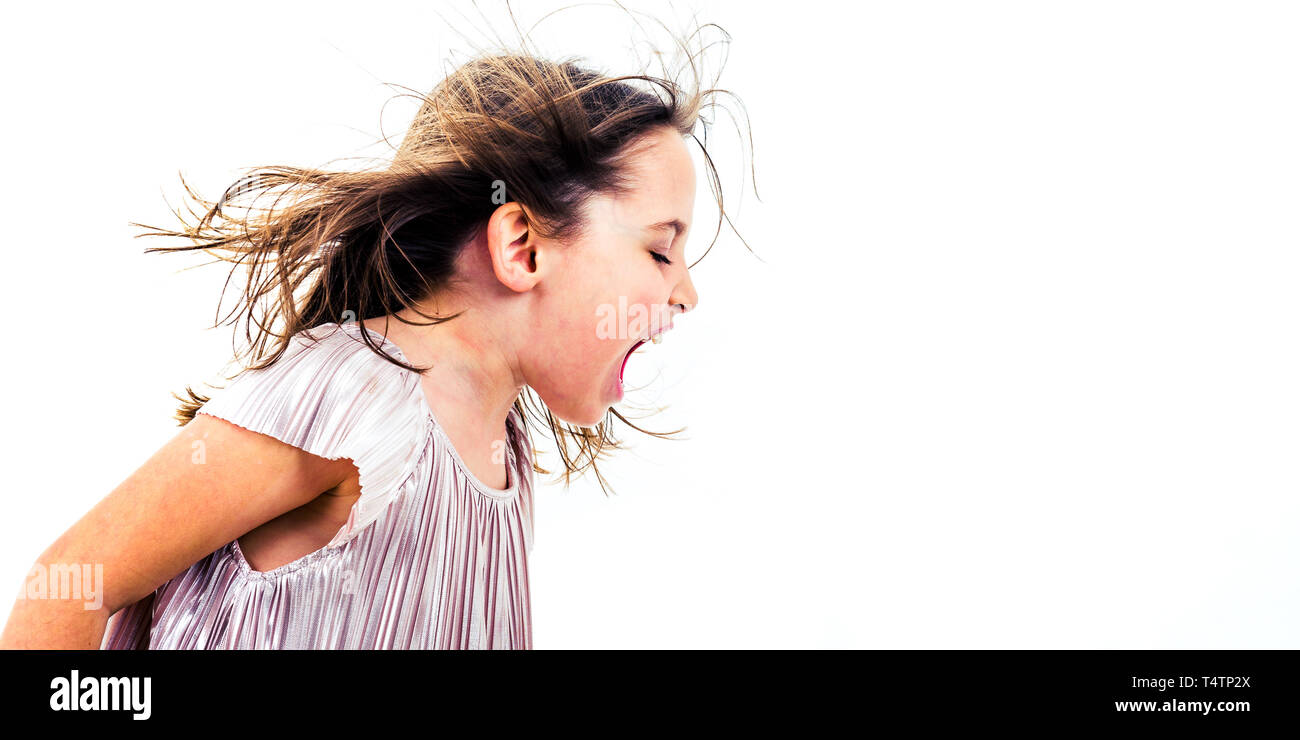 Little girl child yelling, shouting and screaming with bad manners. Angry upset girl is arguing ...