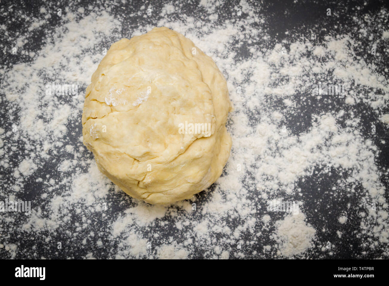 Raw dough is on the table with flour before cooking cottage cheese ...