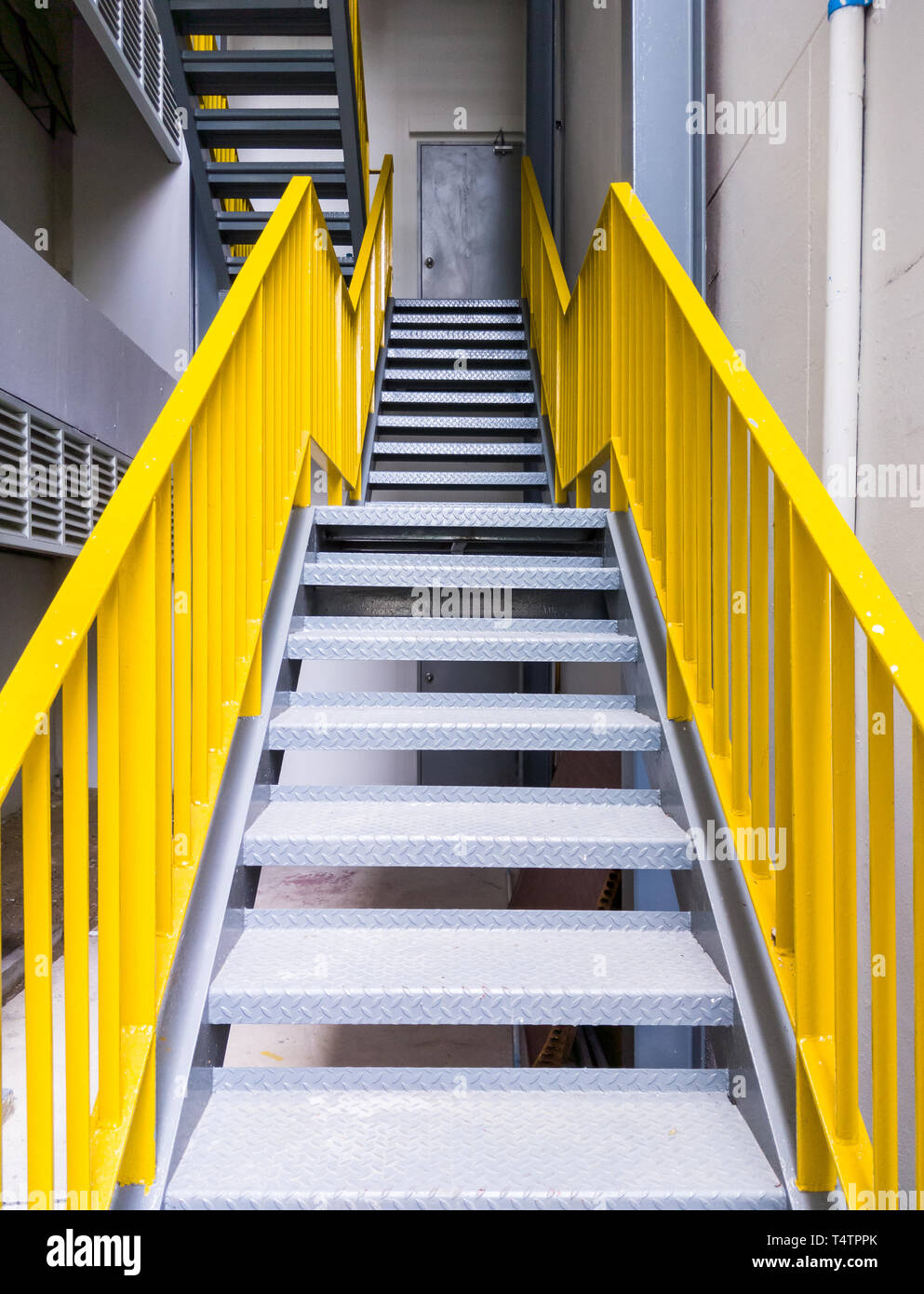 Metal fire escape with the yellow ladder on the office building Stock ...