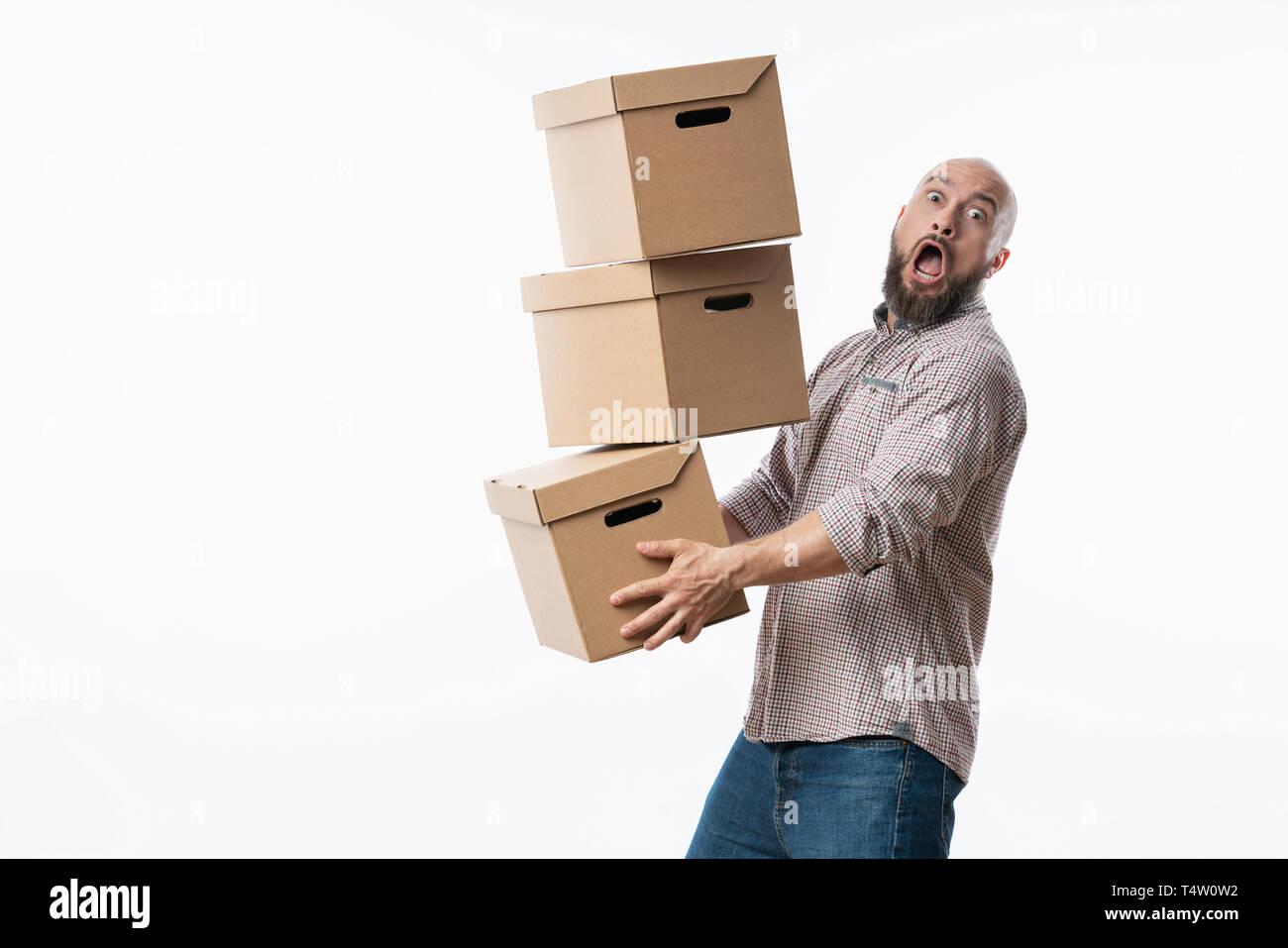 Young man carrying and dropping his stack of moving boxes Stock Photo ...