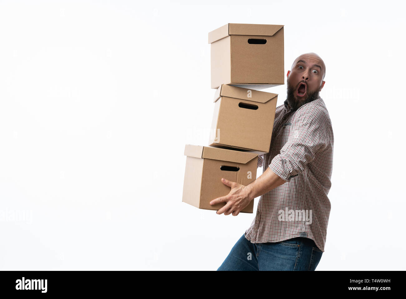 Young man carrying and dropping his stack of moving boxes Stock Photo ...
