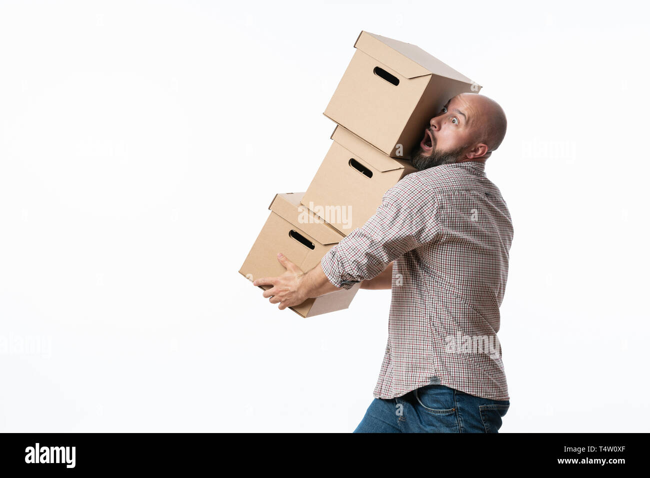 Young man carrying and dropping his stack of moving boxes Stock Photo ...