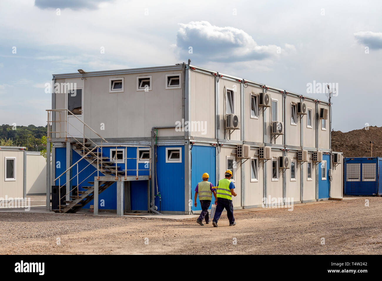 Workers at mobile containers and cabins base for the site manager and ...