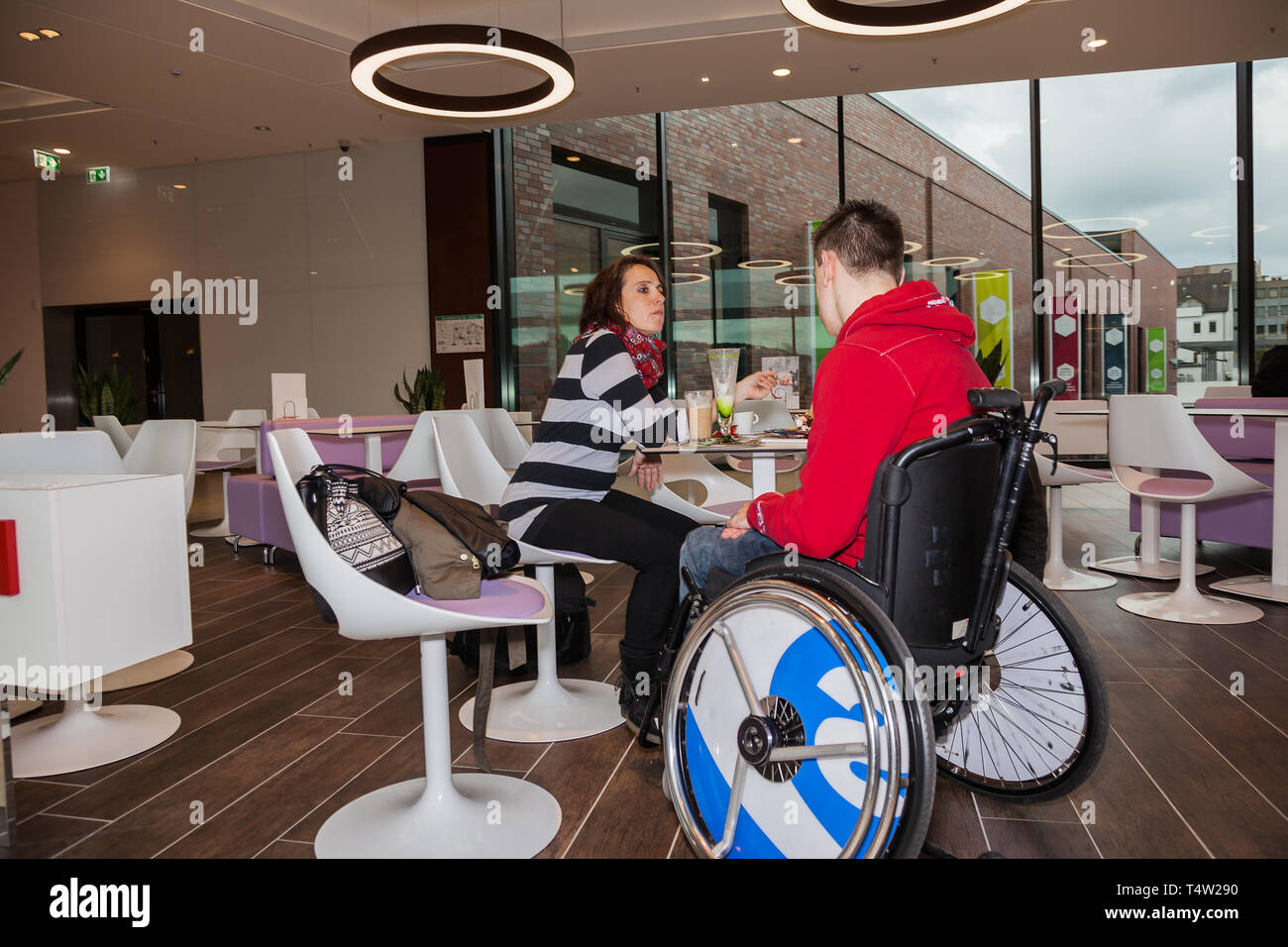 Mother with handicapped son in an ice cream parlor Stock Photo - Alamy