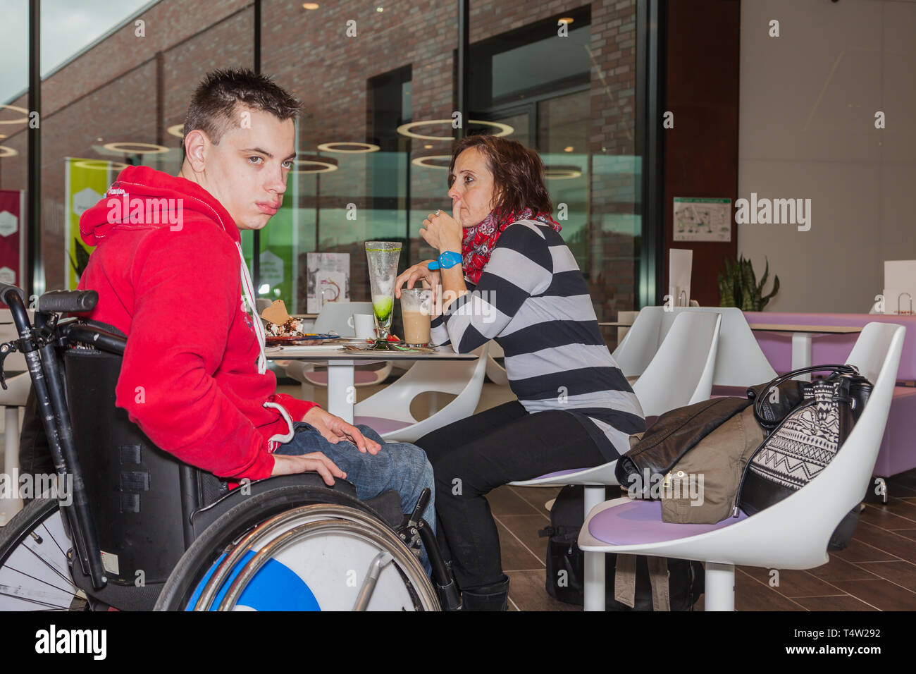 Mother with handicapped son in an ice cream parlor Stock Photo - Alamy