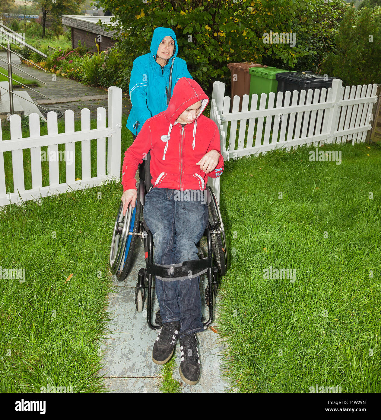 Woman hugging man in wheelchair hi-res stock photography and images - Alamy