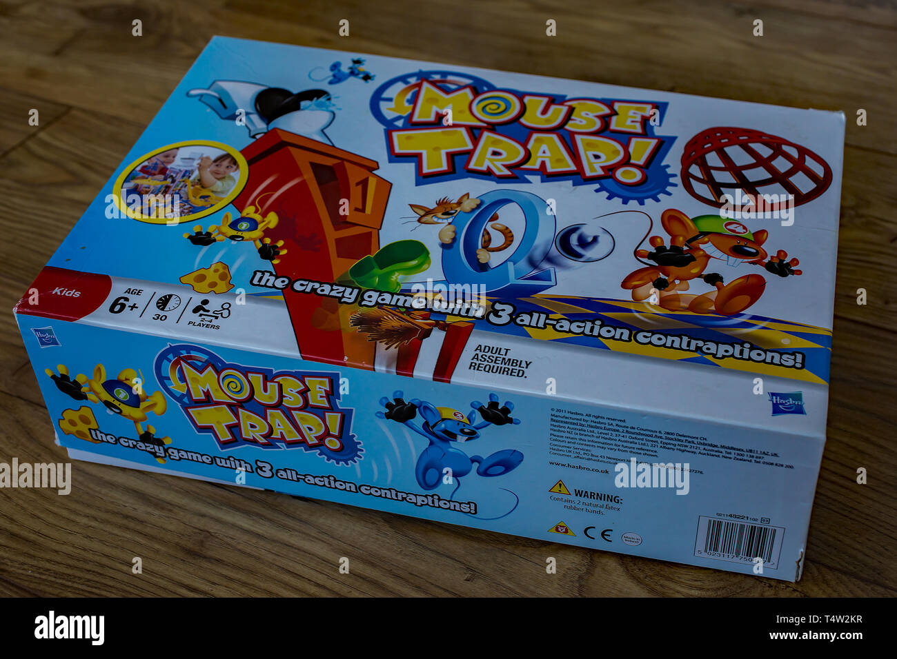 Close up or Hasbro Mousetrap game all boxed up on a wooden floor ready ...
