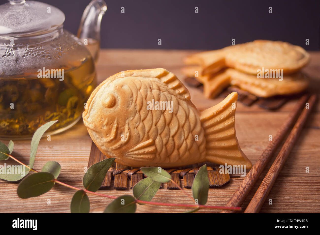Taiyaki Japanese street food fish-shaped sweet waffle on wooden table ...