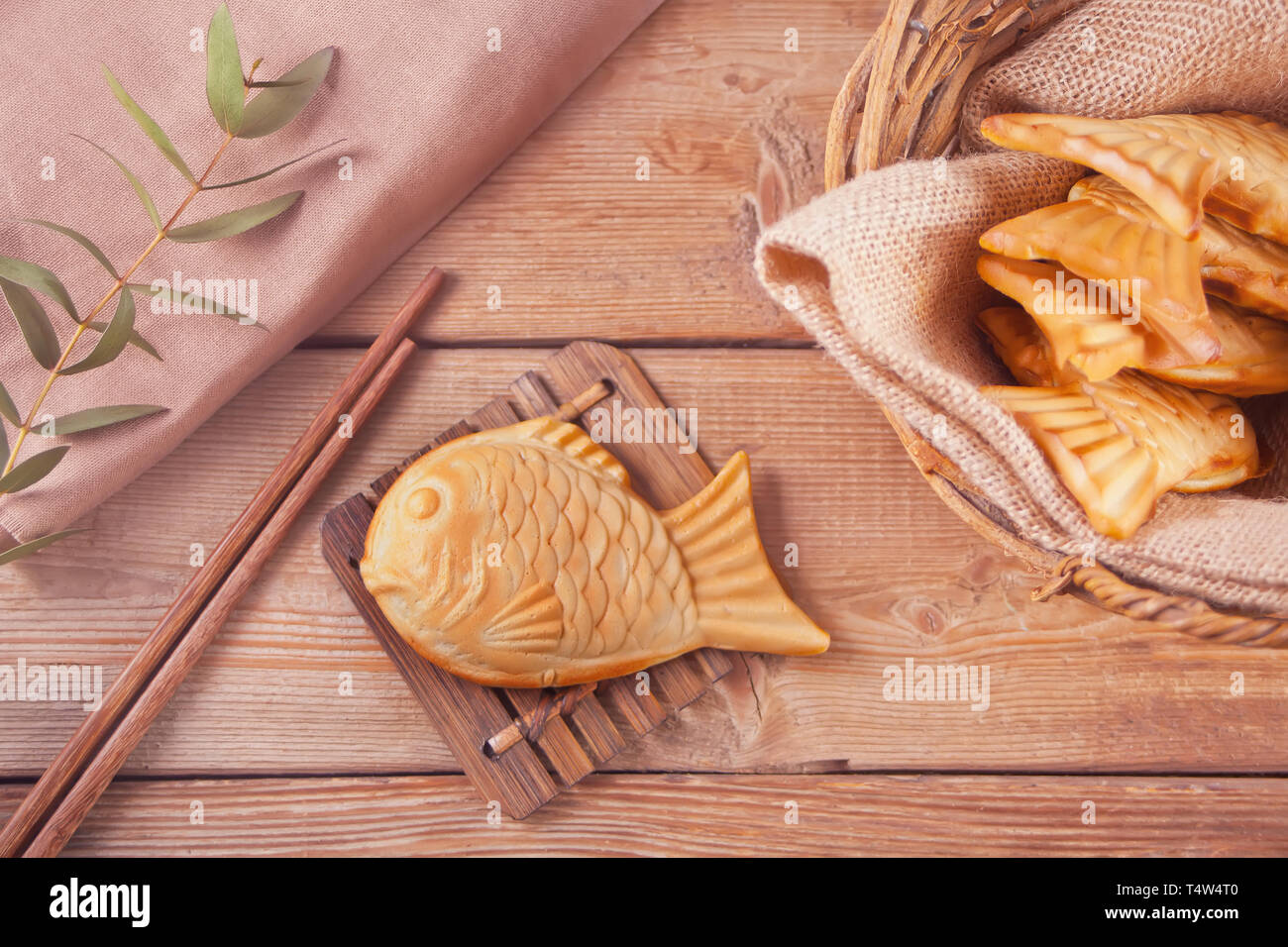 Taiyaki Japanese street food fish-shaped sweet waffle on wooden table ...