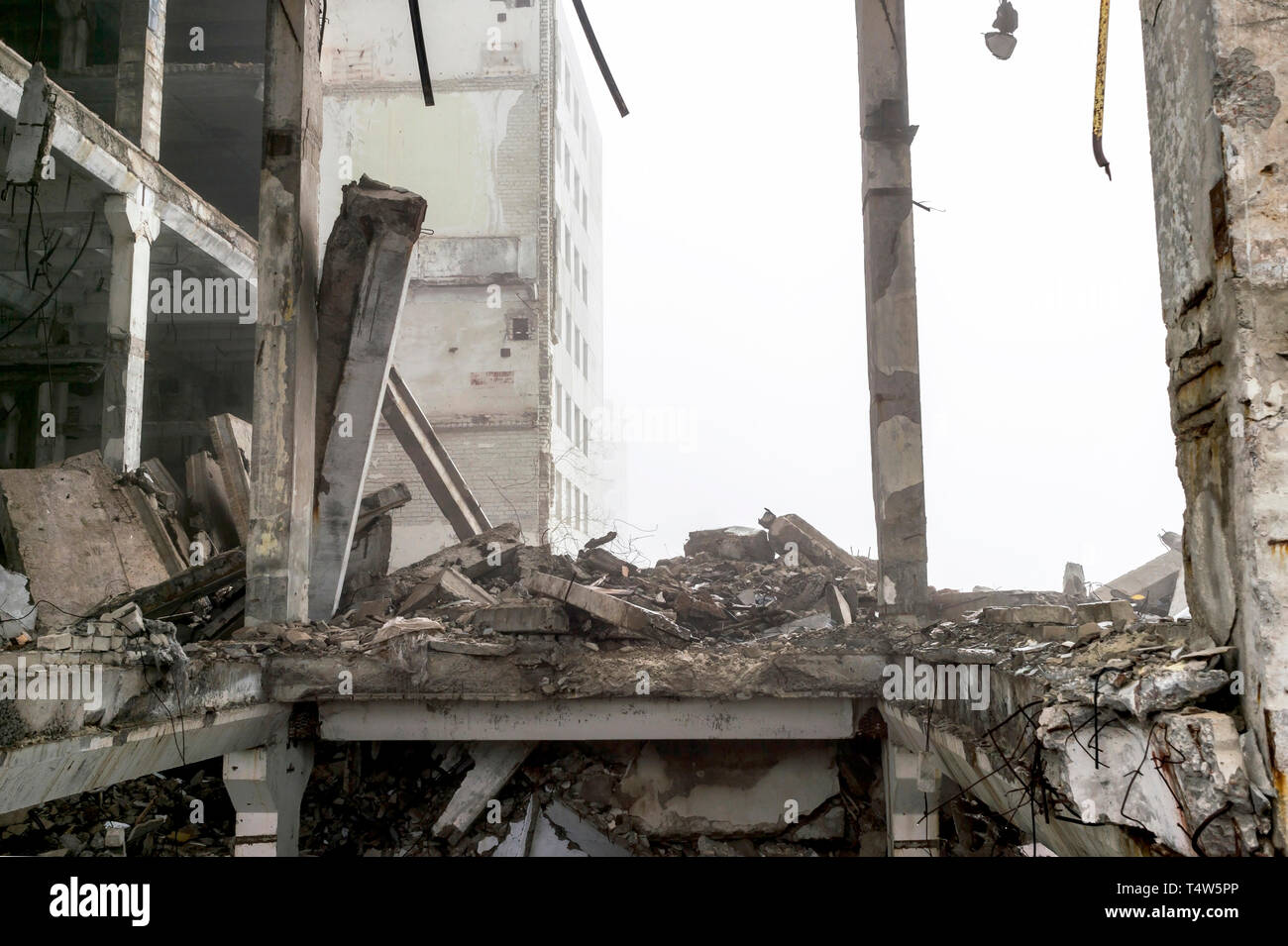 The destroyed big concrete building in a foggy haze. The remains of the ...
