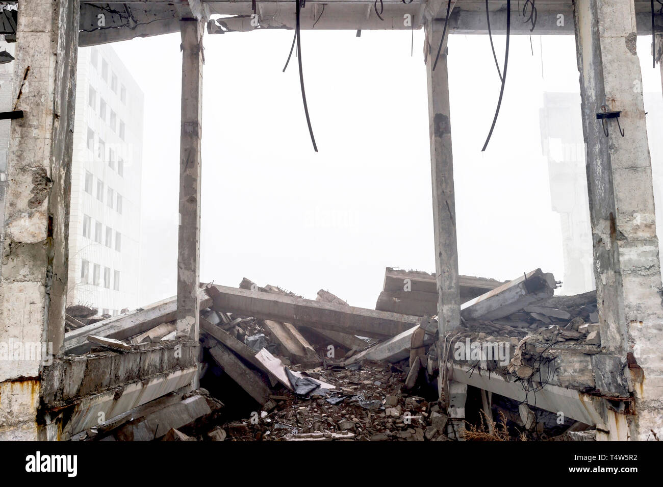 The destroyed big concrete building in a foggy haze. The remains of the ...