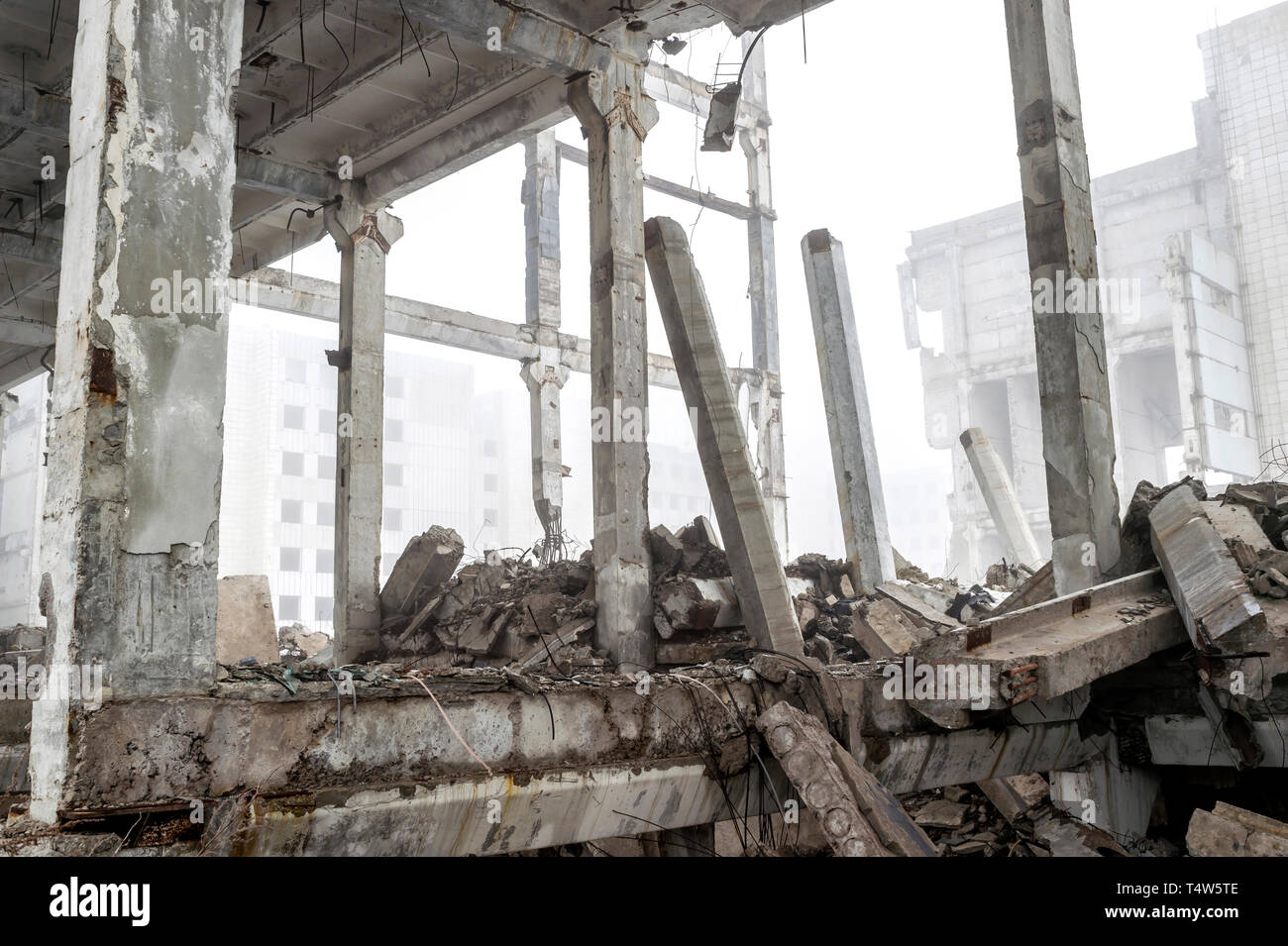 The destroyed big concrete building in a foggy haze. The remains of the ...