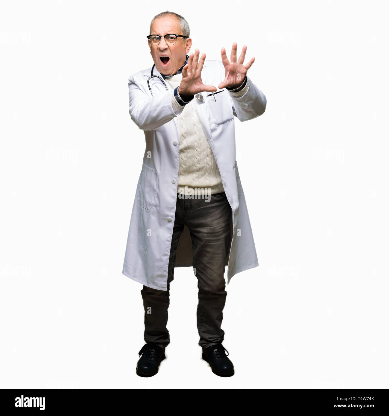 Handsome senior doctor man wearing medical coat afraid and terrified ...