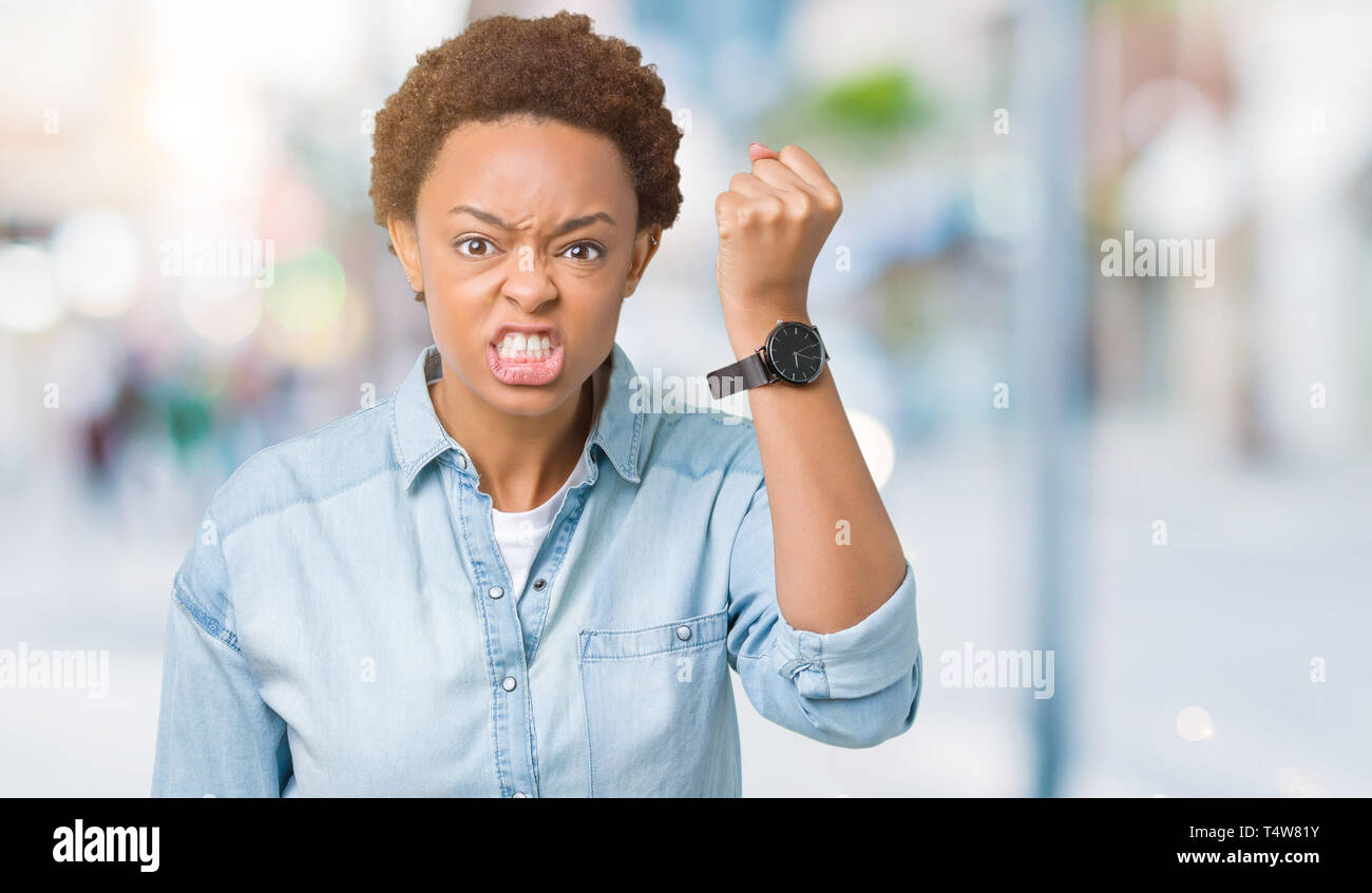 Young beautiful african american woman over isolated background angry ...