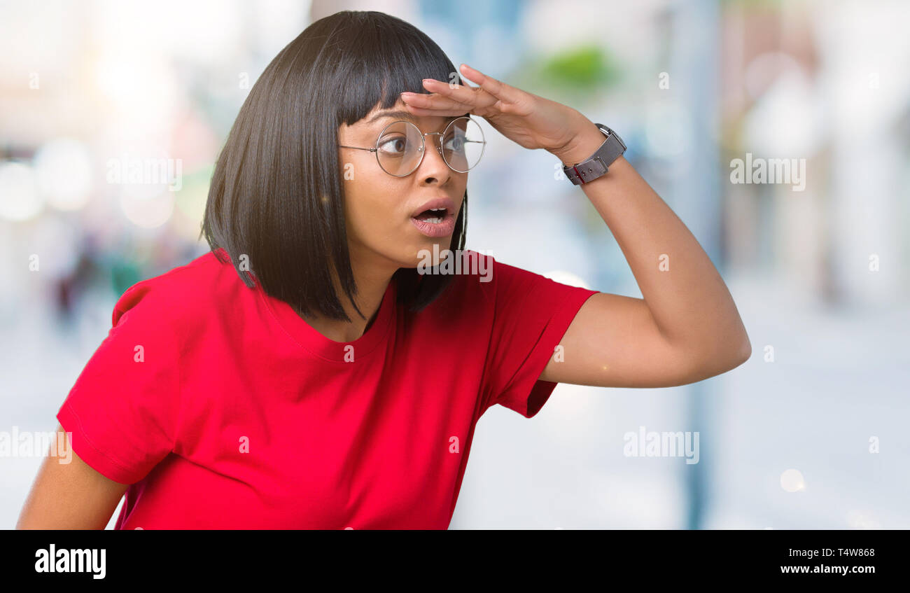 Beautiful young african american woman wearing glasses over isolated ...