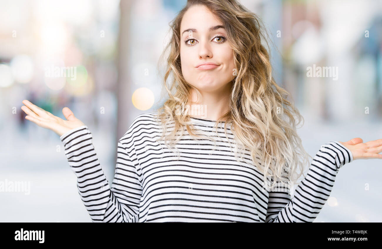 Beautiful young blonde woman wearing stripes sweater over isolated ...