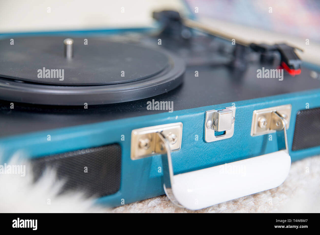 Vintage blue record player on the carpet floor Stock Photo - Alamy