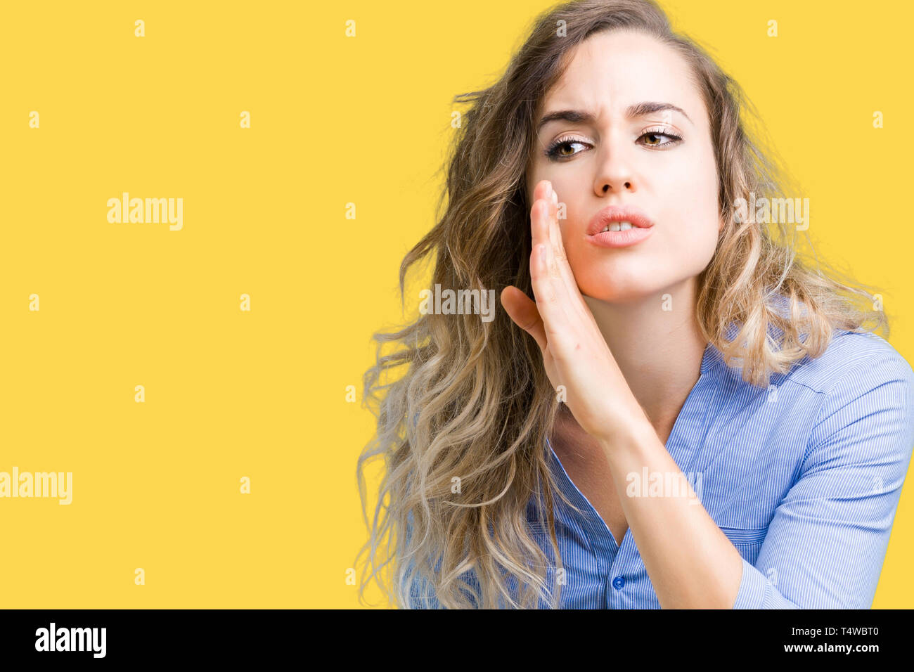 Beautiful young blonde business woman over isolated background hand on ... Beautiful young blonde business woman over isolated background hand on ...