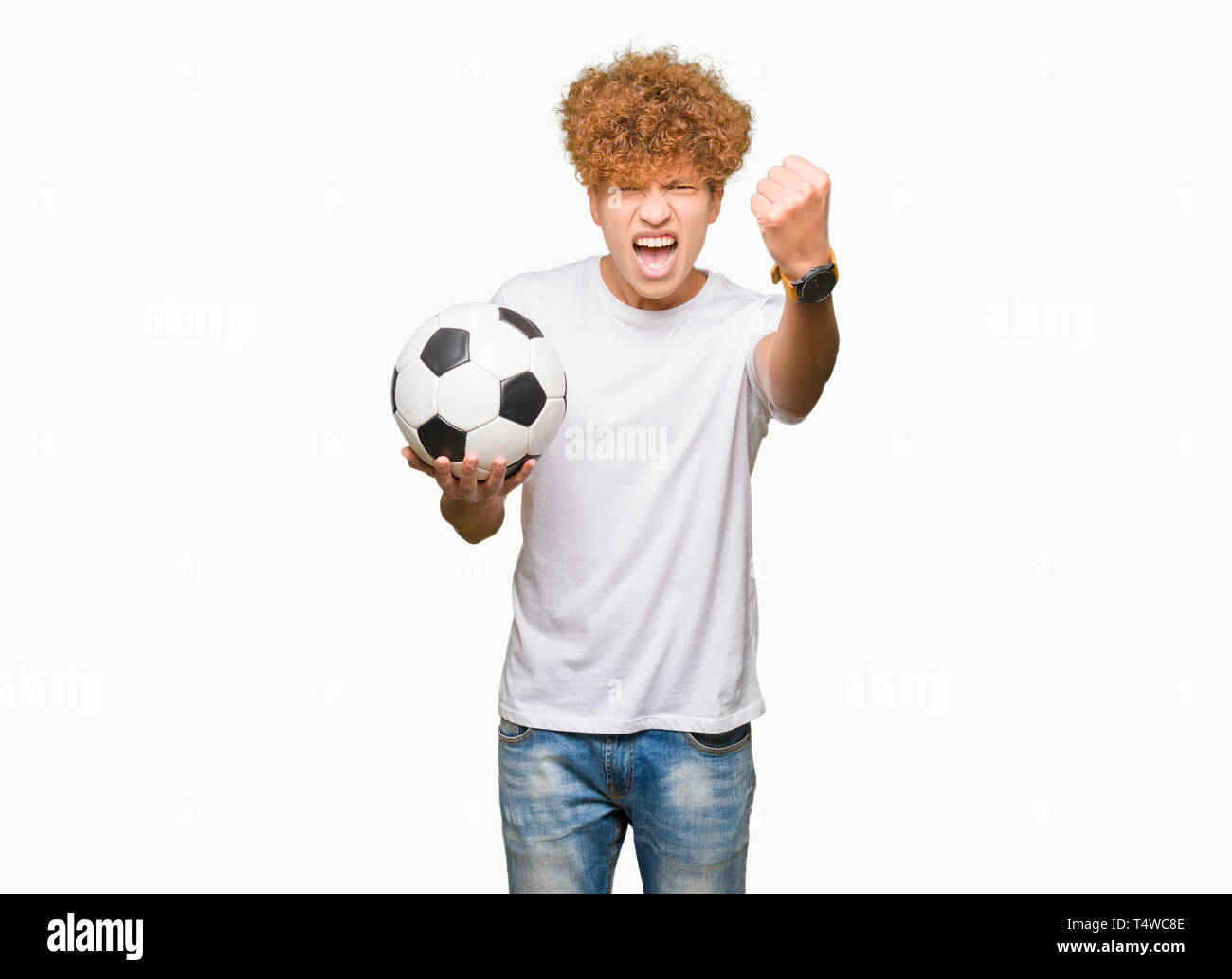 Young handsome man holding soccer football ball annoyed and frustrated ...