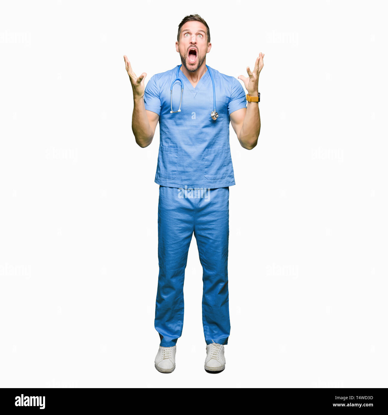 Handsome doctor man wearing medical uniform over isolated background ...
