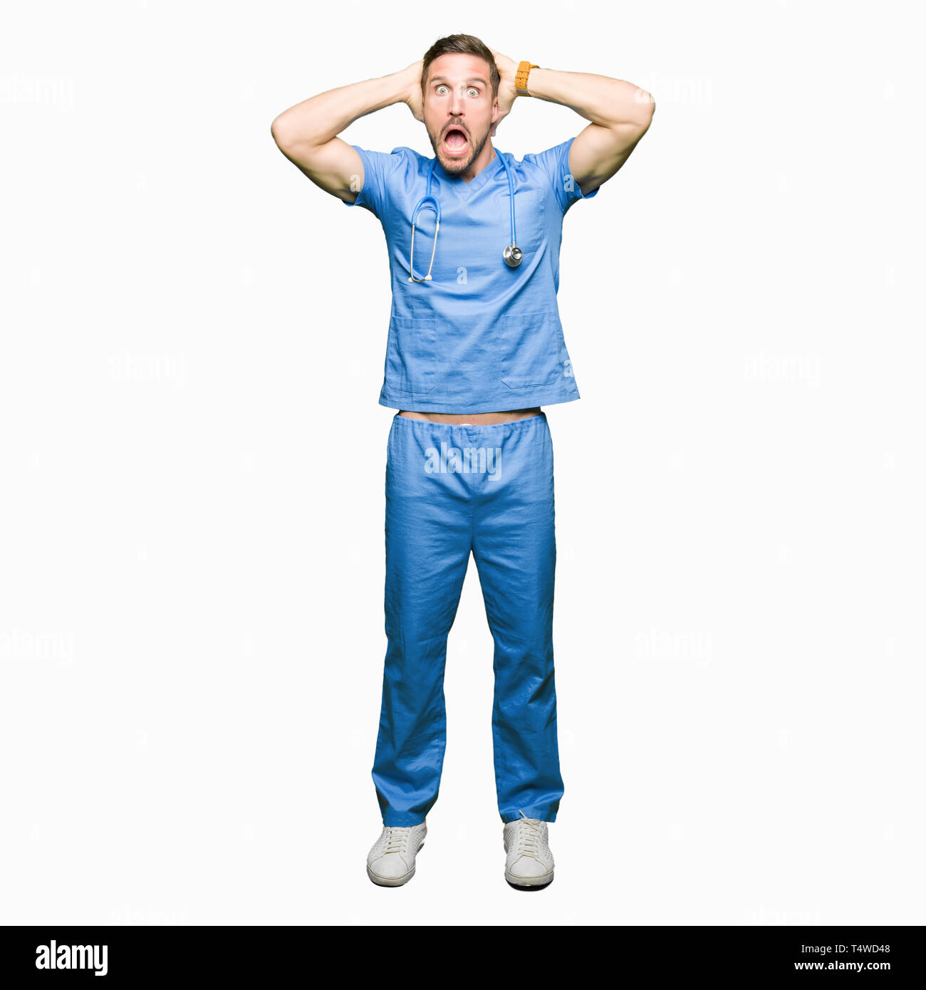 Handsome doctor man wearing medical uniform over isolated background ...