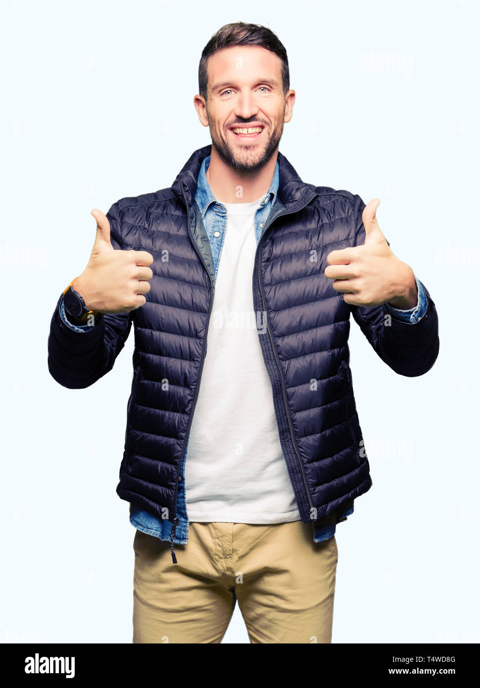 Handsome man wearing winter coat success sign doing positive gesture ...