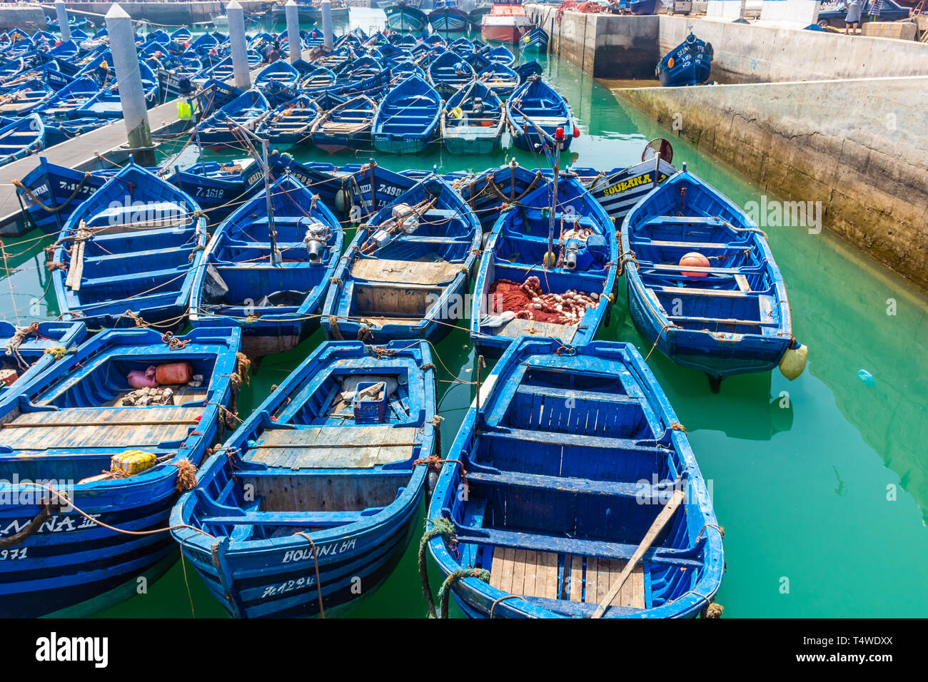 Traditional blue boats in the harbor of Essaouira, Morocco Stock Photo ...