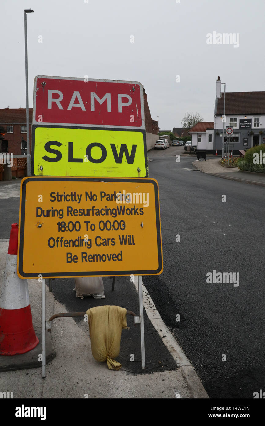 Road signs to warn and inform motorists of road resurfacing work taking ...