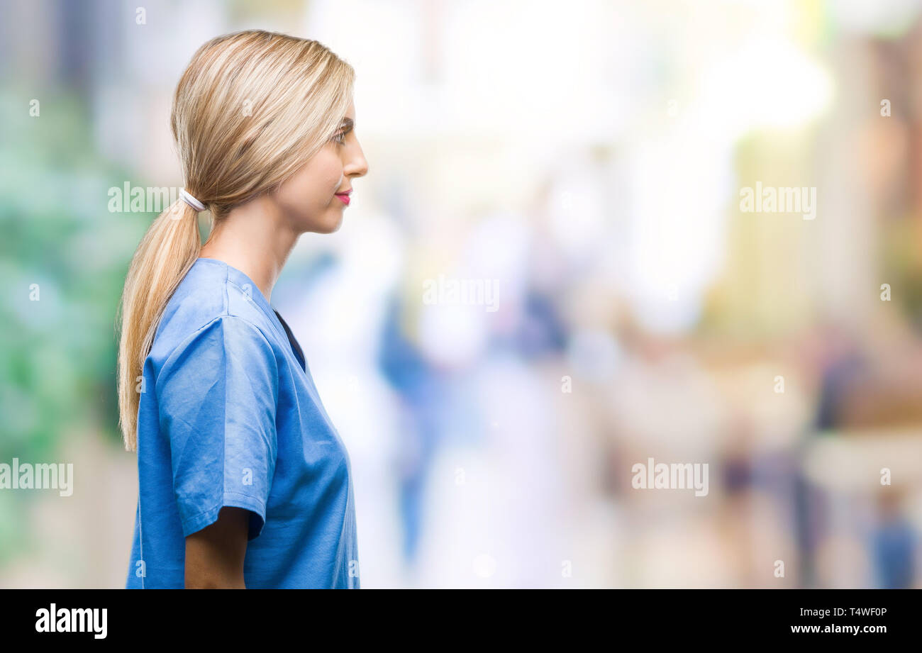 Young beautiful blonde doctor surgeon nurse woman over isolated ...