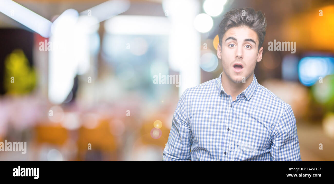 Young handsome business man over isolated background afraid and shocked with surprise expression ...